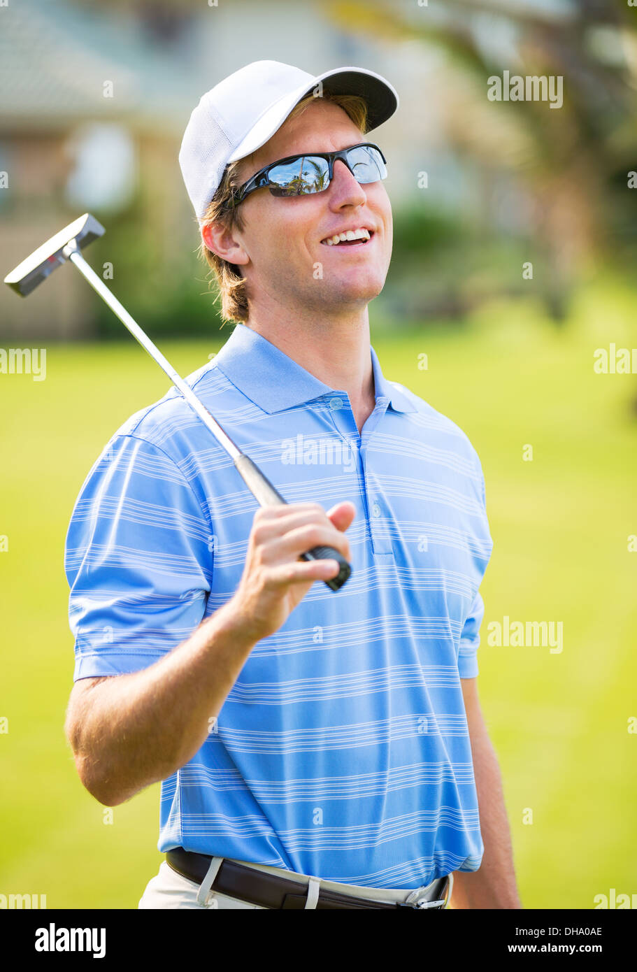 Athletic young man playing golf, Portrait of Golfer on Course with ...