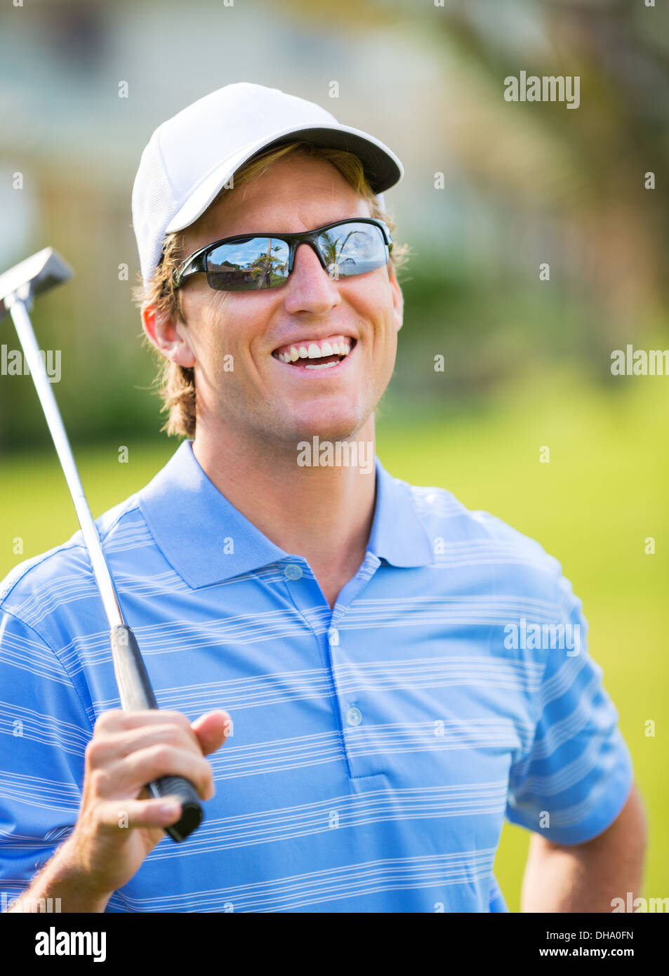 Athletic young man playing golf, Portrait of Golfer on Course with ...