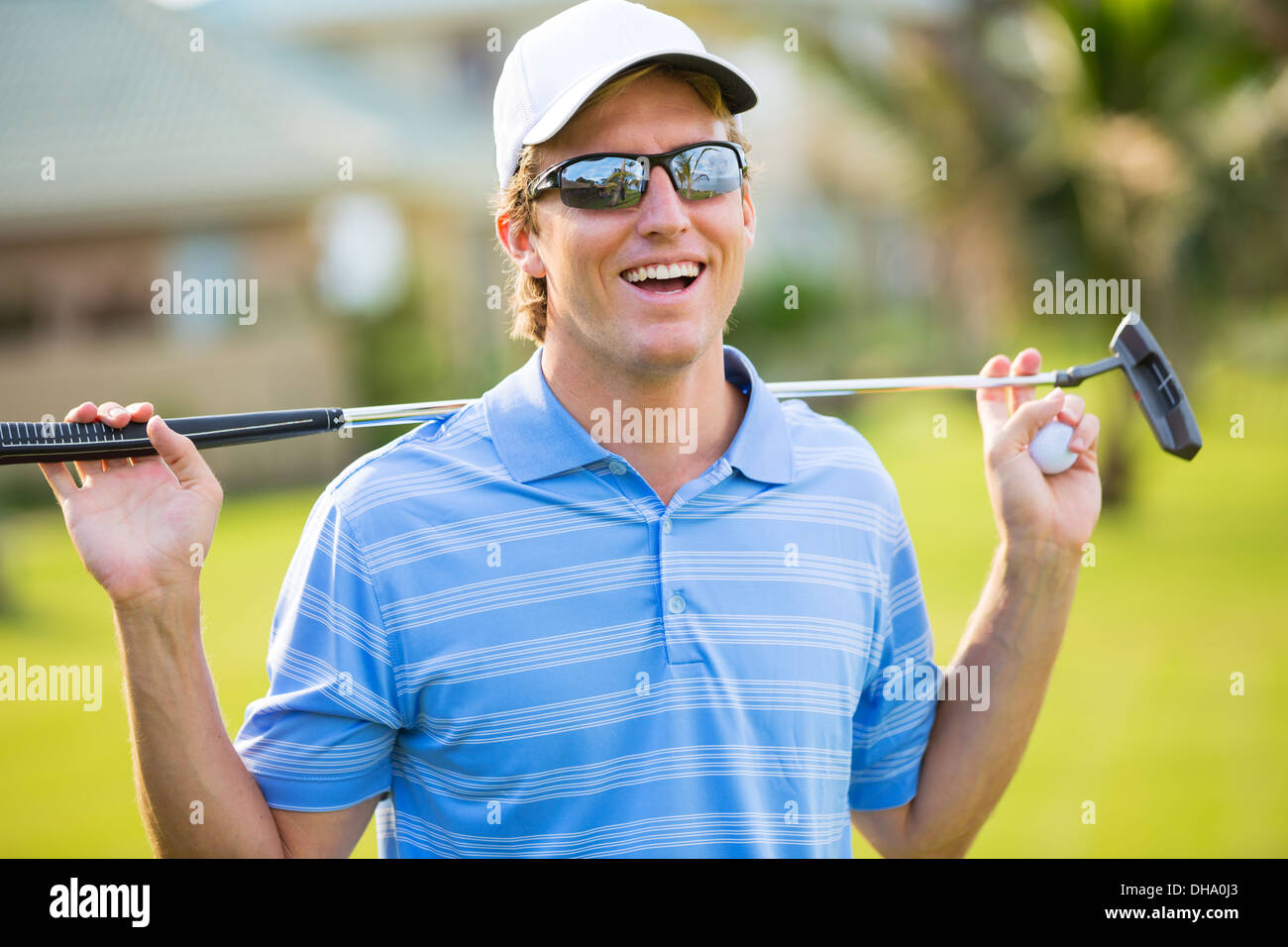 Athletic young man playing golf, Portrait of Golfer on Course with ...