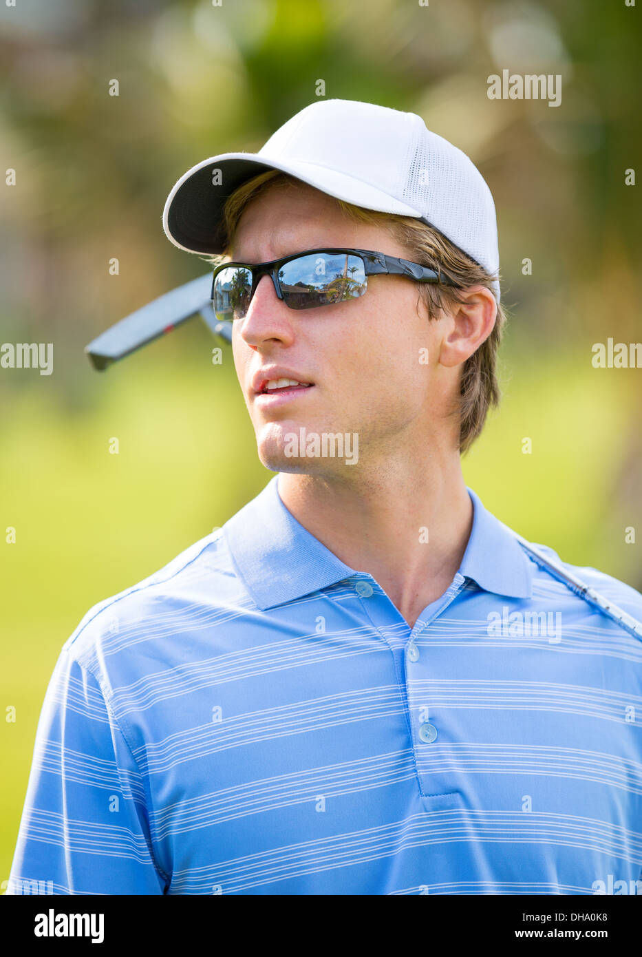 Athletic young man playing golf, Portrait of Golfer on Course with ...