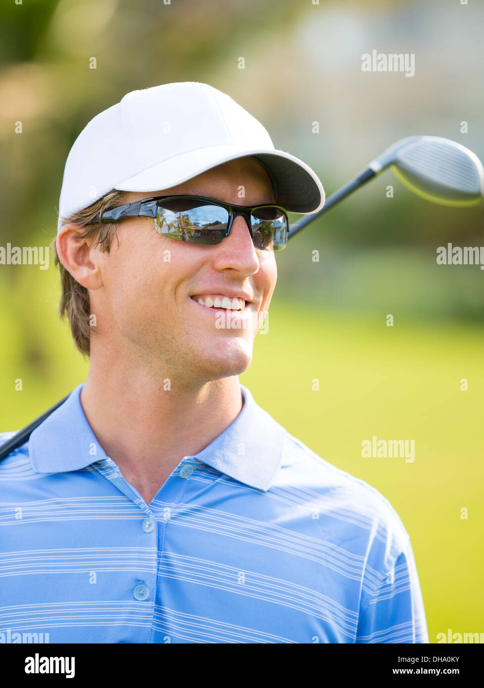 Athletic young man playing golf, Portrait of Golfer on Course with ...