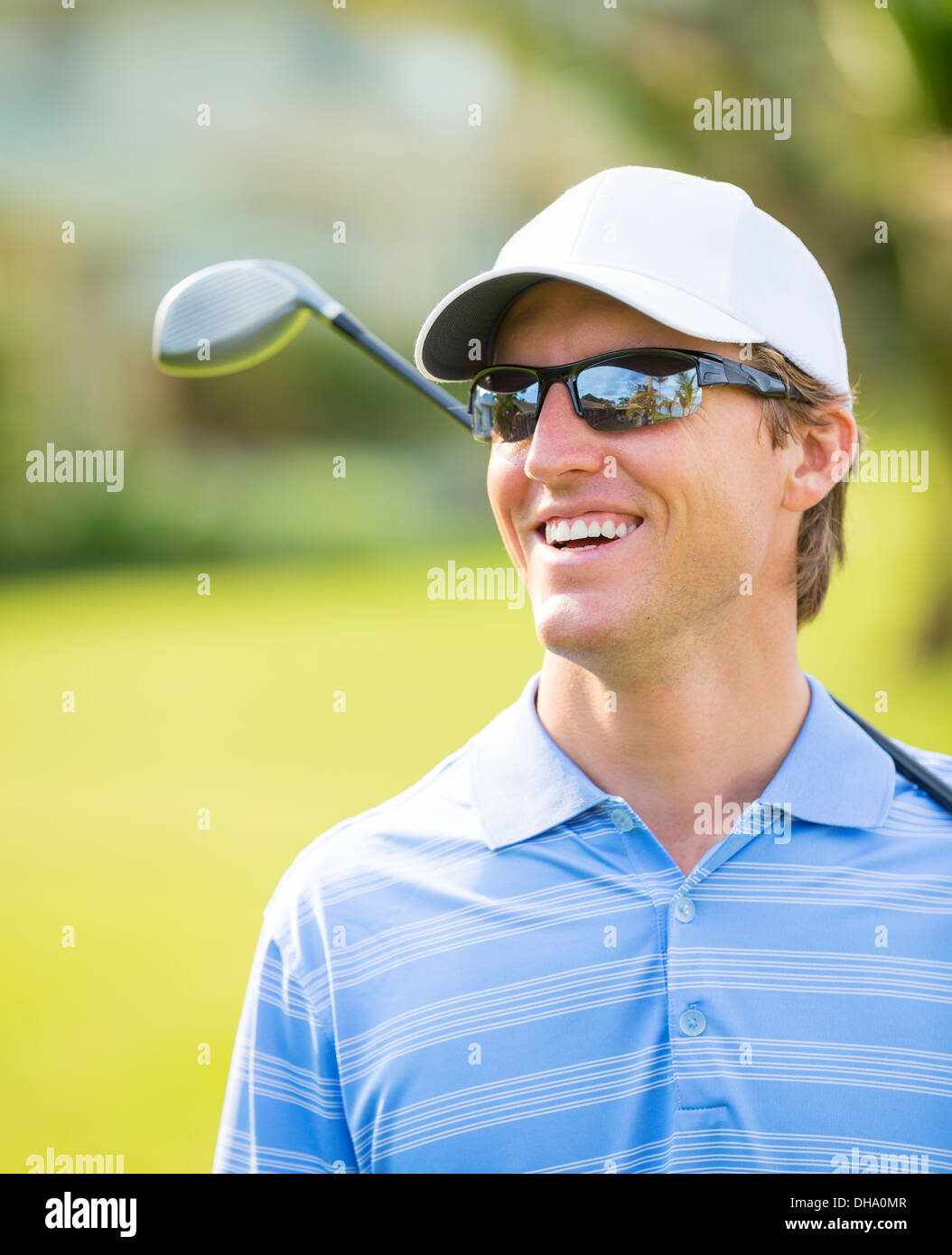Athletic young man playing golf, Portrait of Golfer on Course with ...