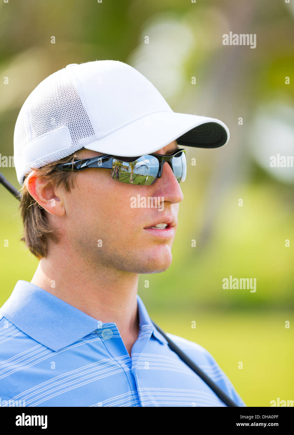 Athletic young man playing golf, Portrait of Golfer on Course with ...