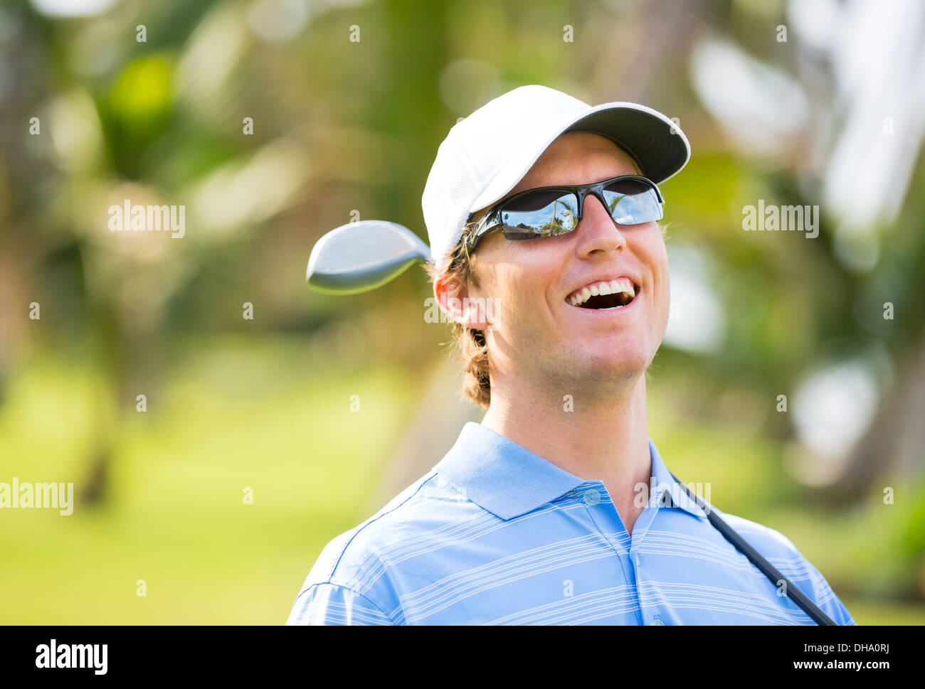 Athletic young man playing golf, Portrait of Golfer on Course with ...