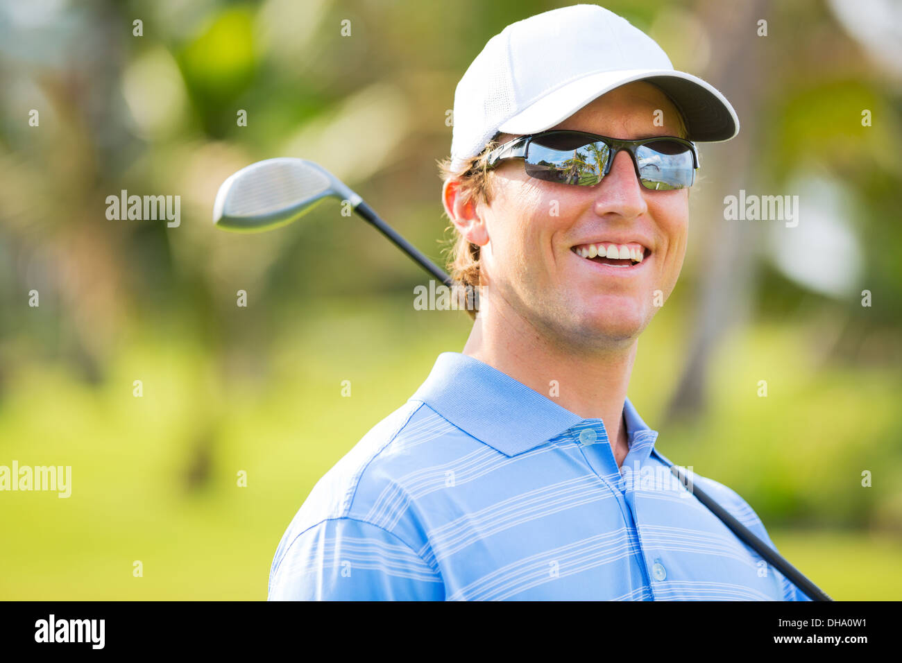 Athletic young man playing golf, Portrait of Golfer on Course with ...