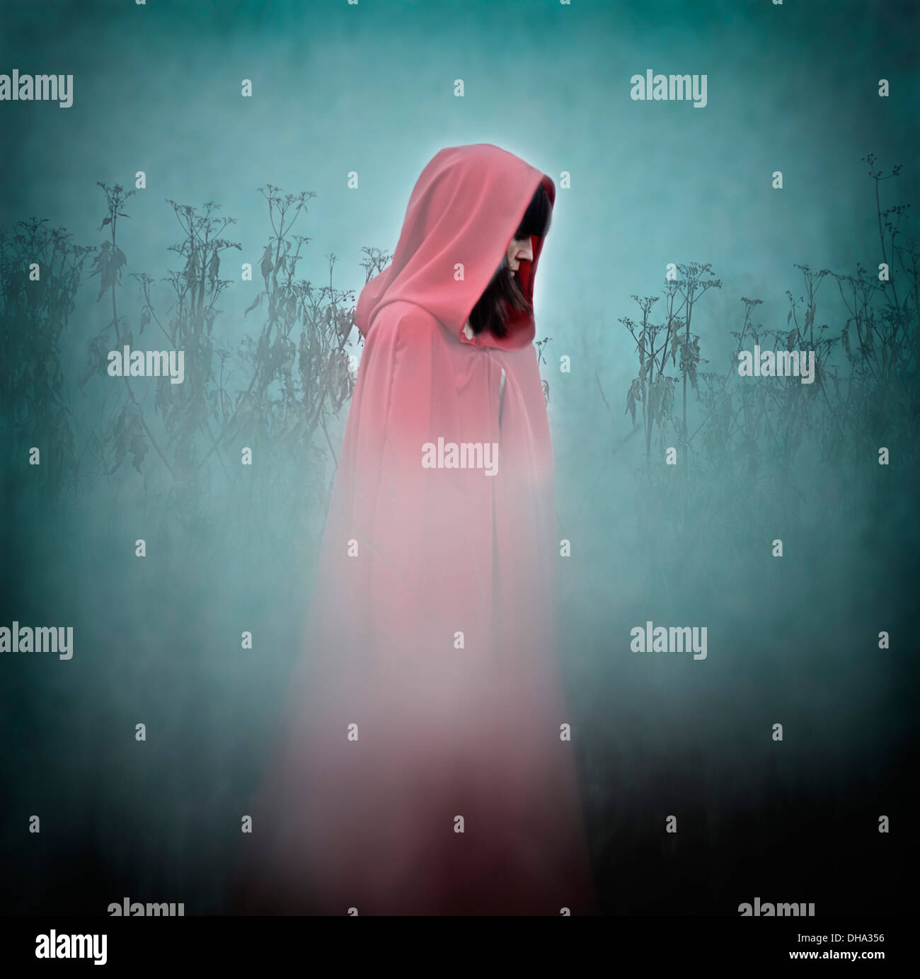 Woman wearing red cape walking outdoors Stock Photo - Alamy