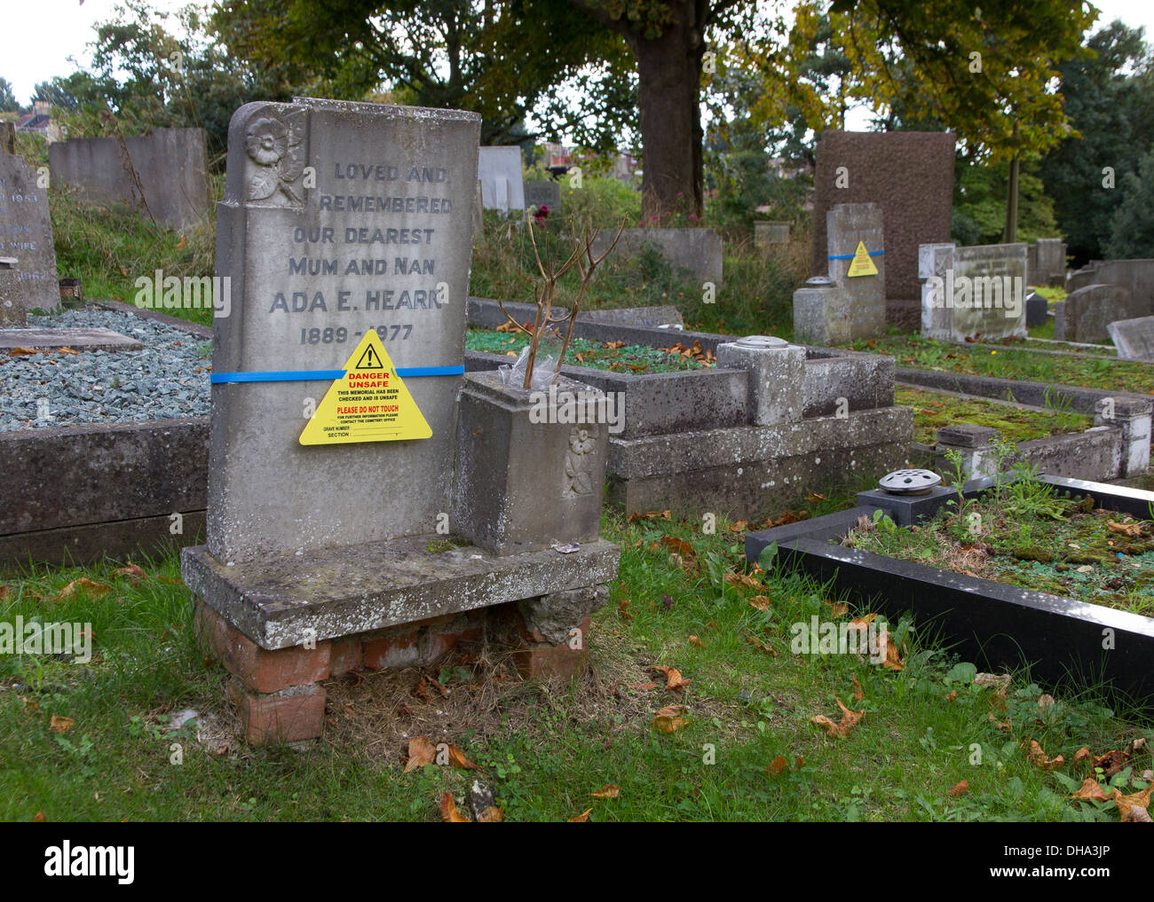 Unsafe monuments in a cemetery marked with warnings pending repair ...