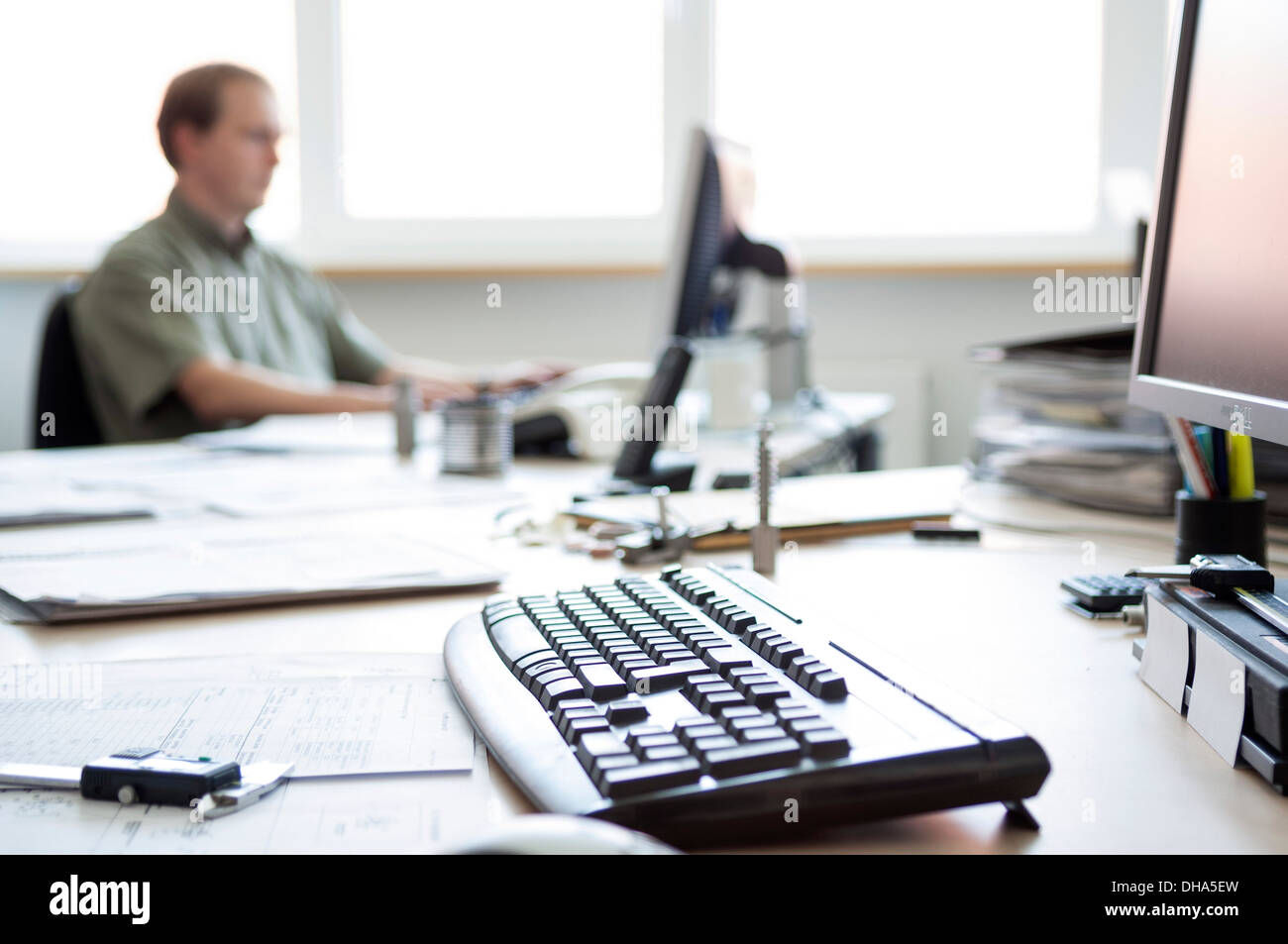 Man on desk Stock Photo - Alamy
