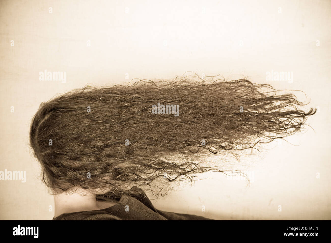 Head and shoulders of a girl with long hair apparently hanging in front ...