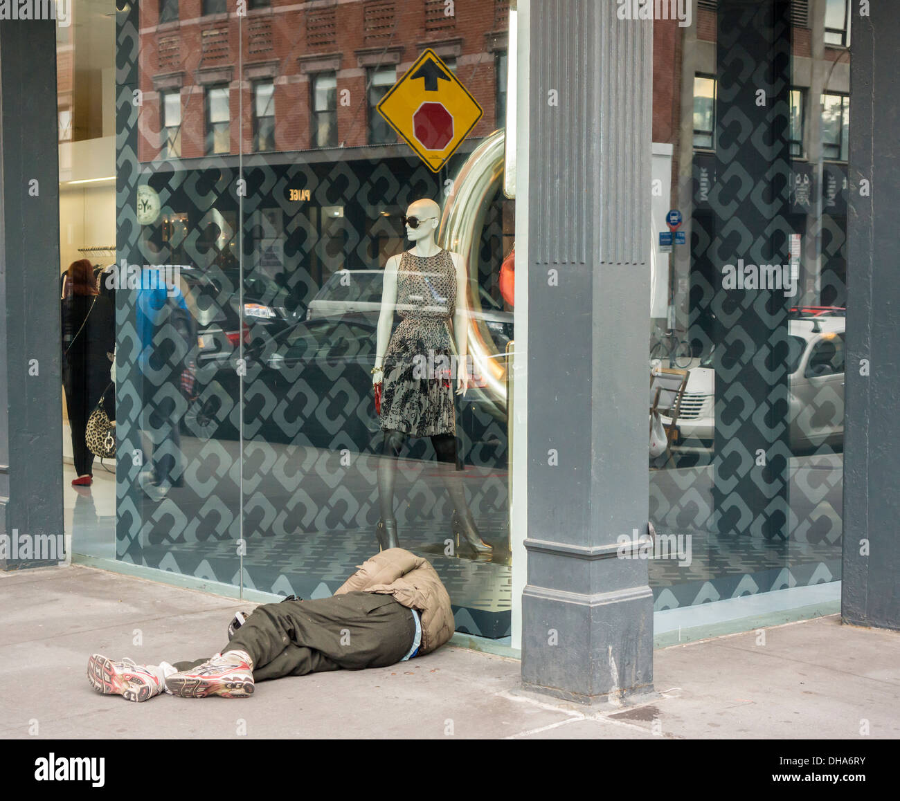 Homeless man sleeping on the sidewalk in front of the Diane Von ...