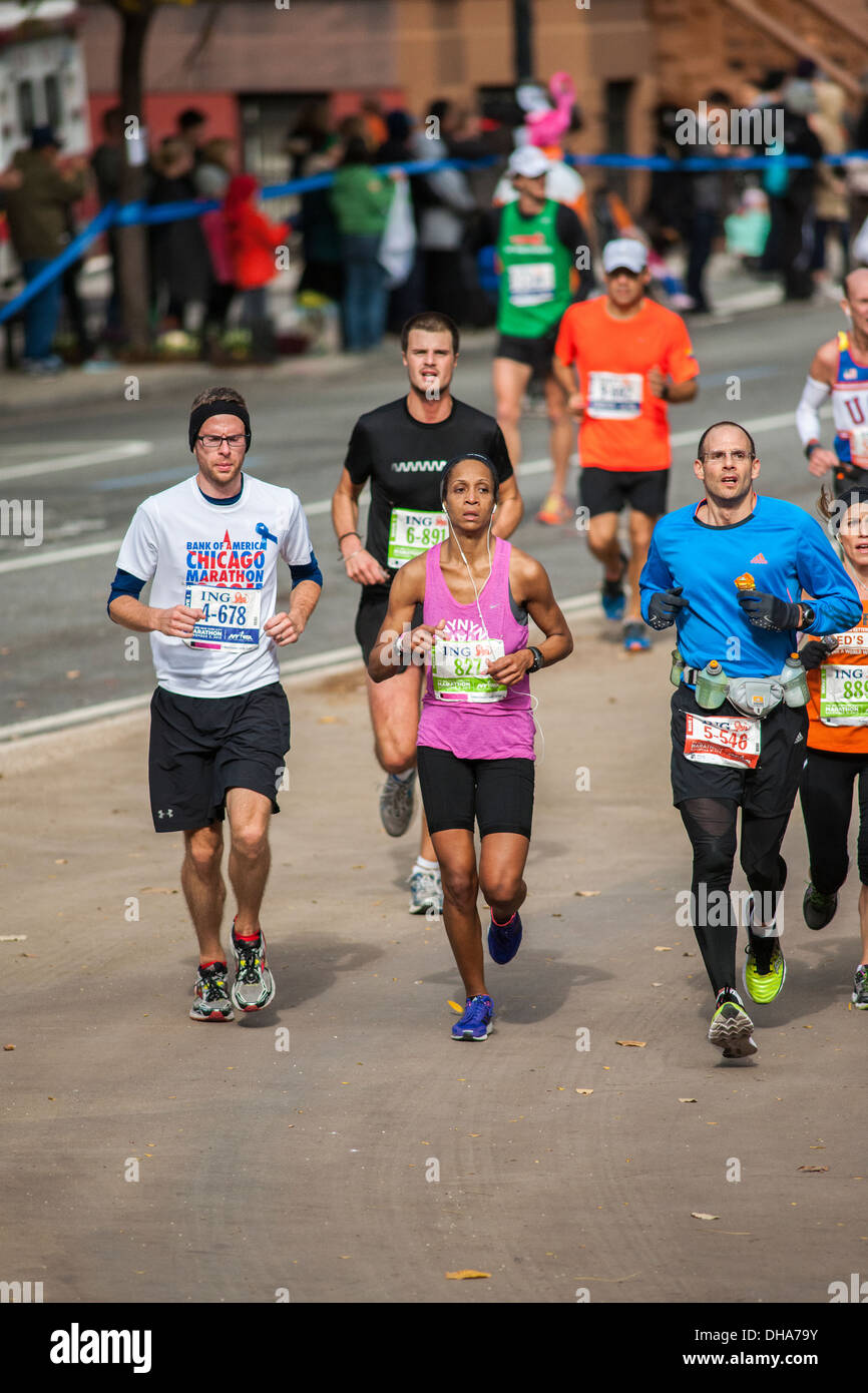Runners pass through Harlem in New York near the 22 mile mark near ...