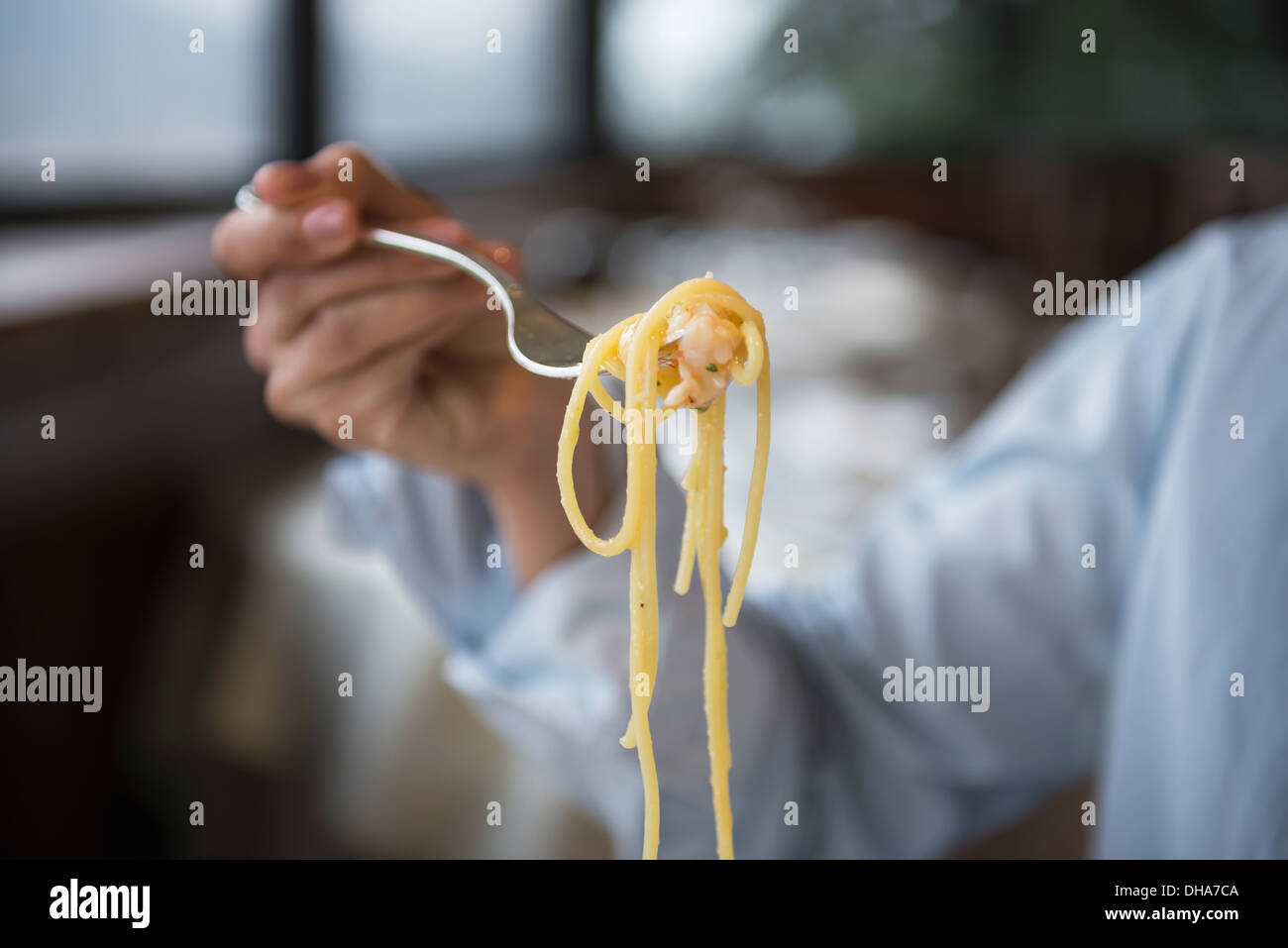 A Hand Holding A Fork Full Of Pasta Stock Photo - Alamy