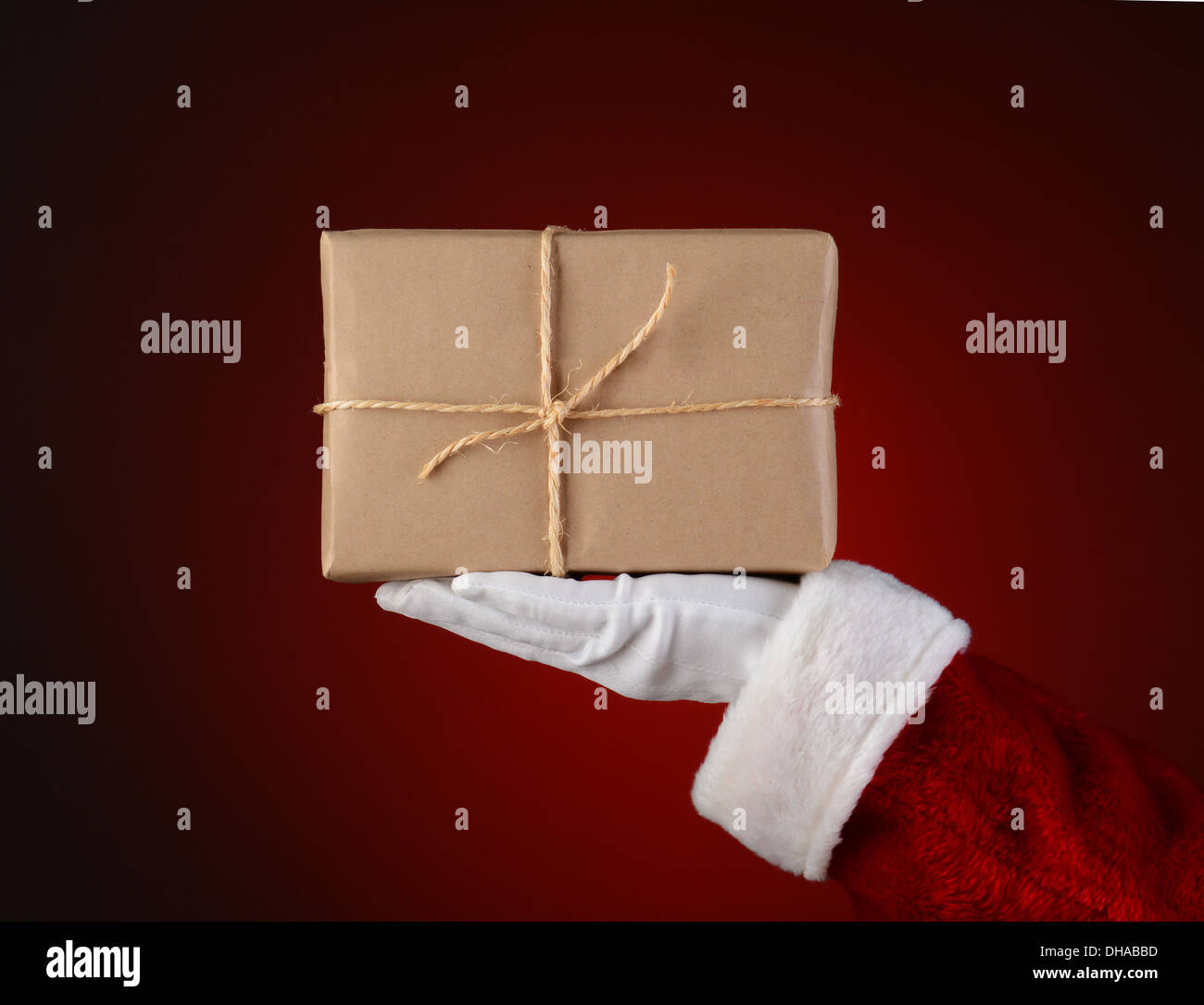Closeup of Santa Claus holding a parcel in the palm of his outstretched ...