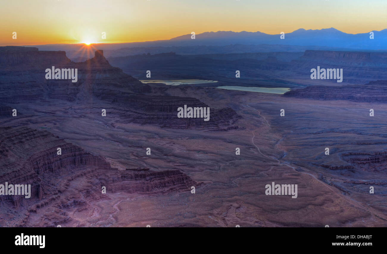 Spectacular sunrise over the purple mesas and and potash ponds seen ...
