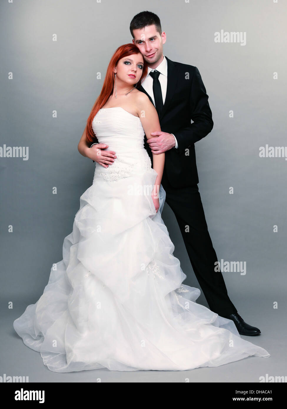 Wedding day. Portrait of happy married couple red haired bride and ...