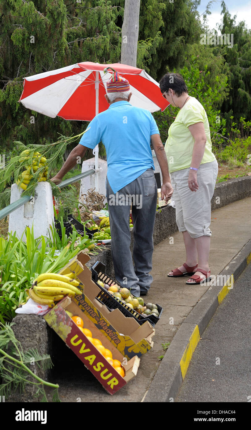 Madeira Portugal. A local old man selling fruit and vegetables to a ...