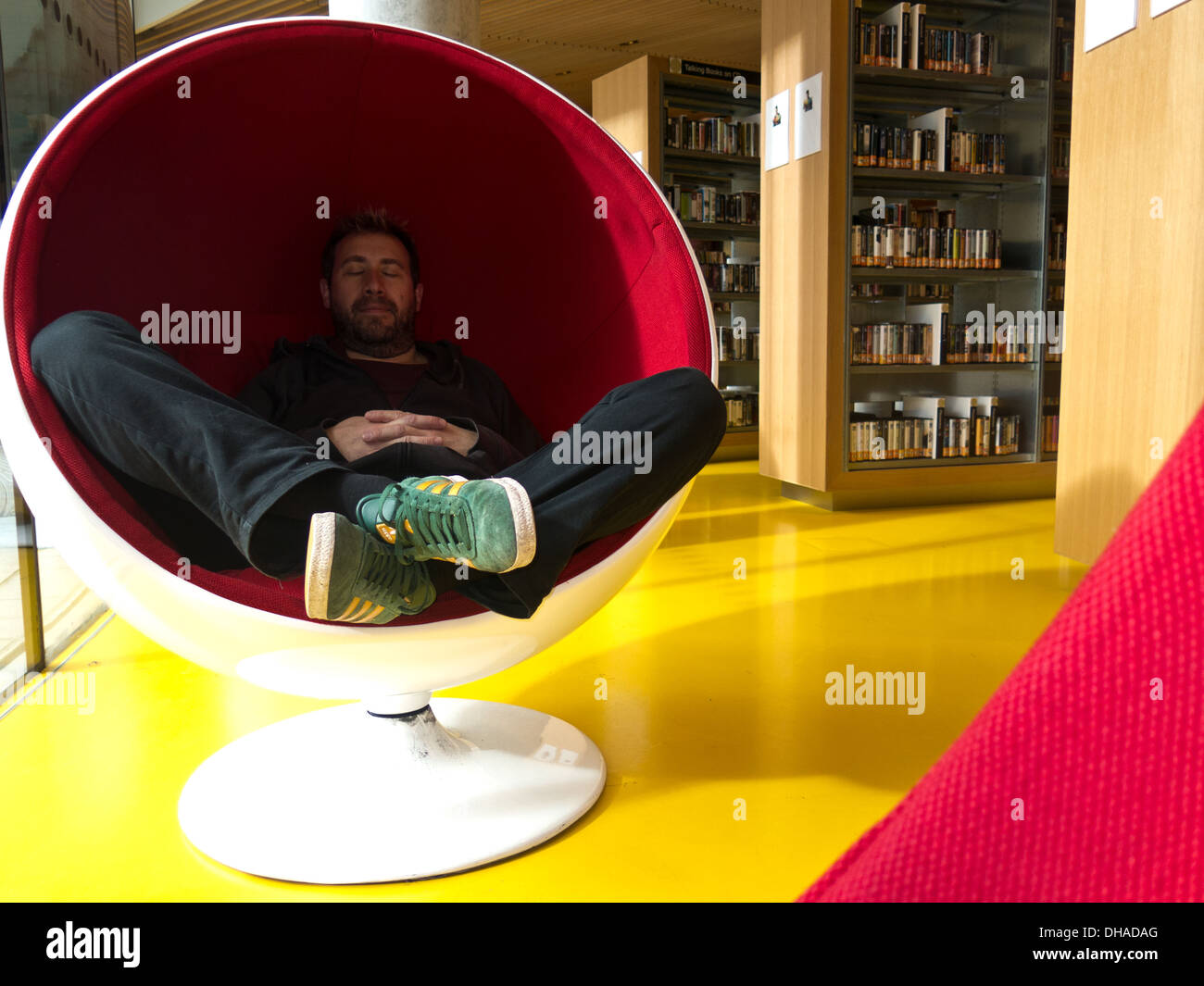 Man relaxing in the music section of the new Birmingham city library ...