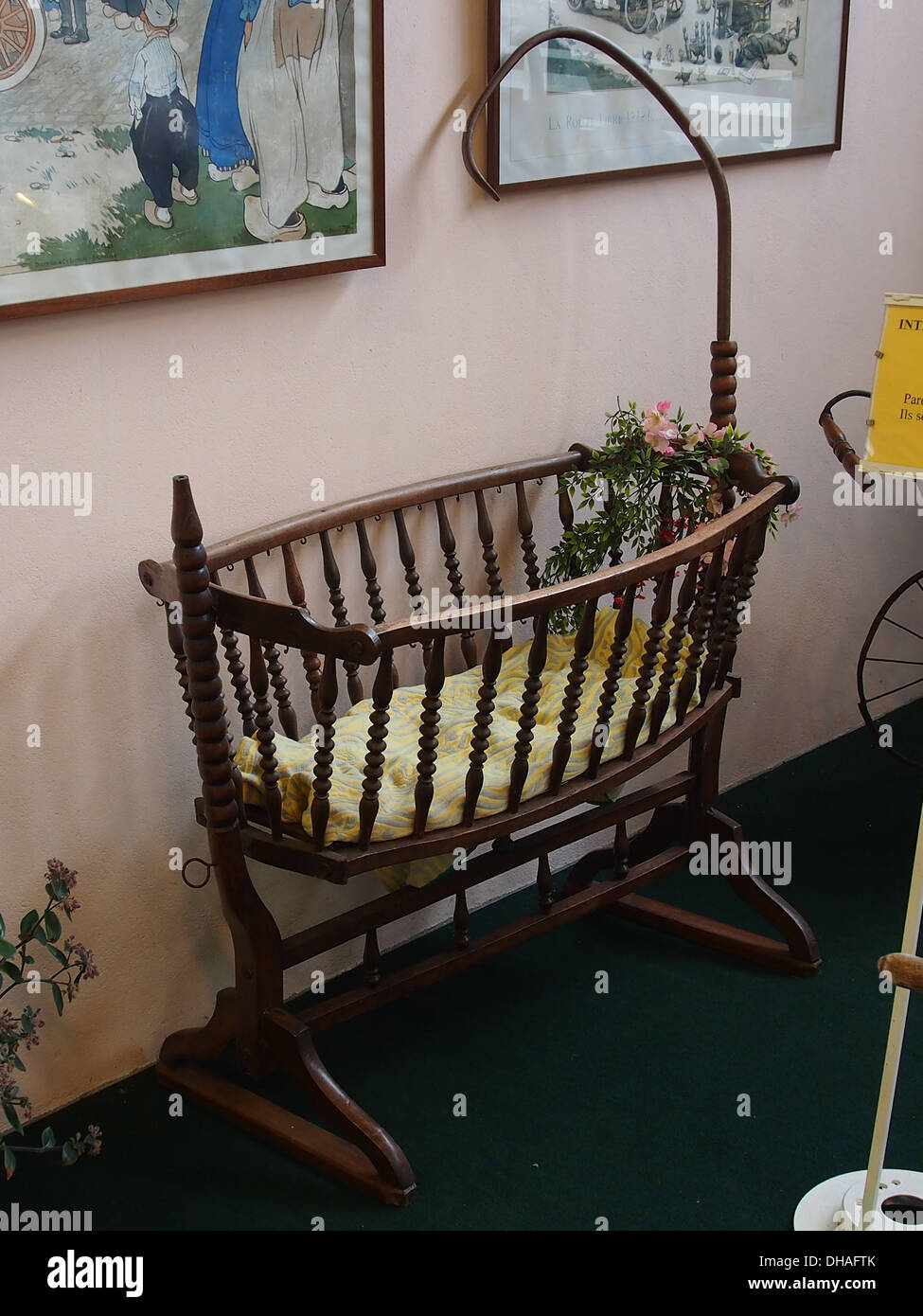 A very old cradle, possibly dating back to the 19th century, reflecting ...