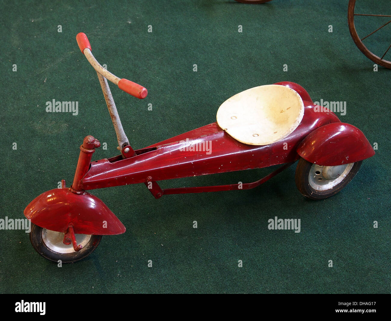 This old tricycle, displayed at the Museum of Automobiles in France, is ...