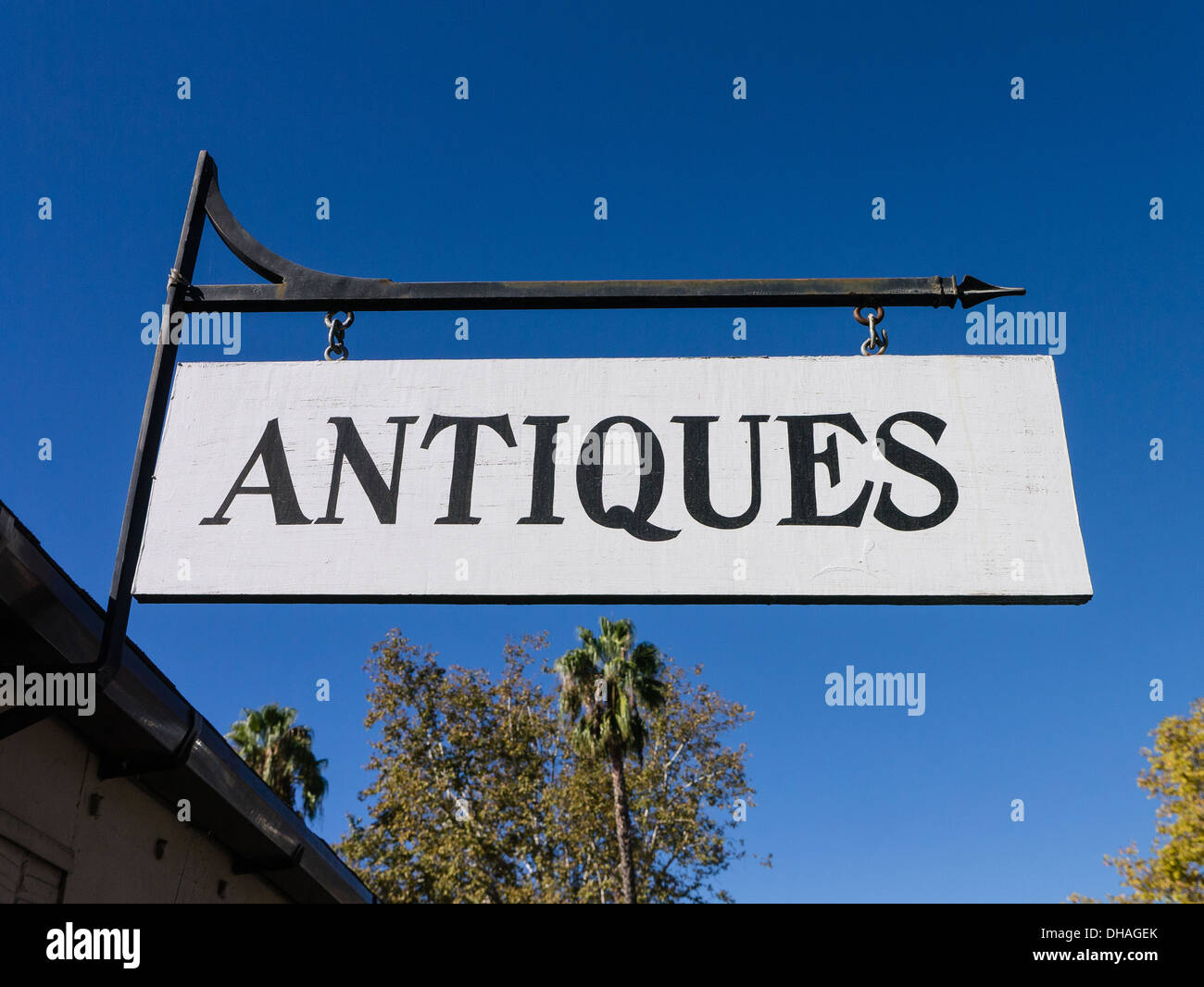 Looking up at the black lettering on white background of a wooden sign ...
