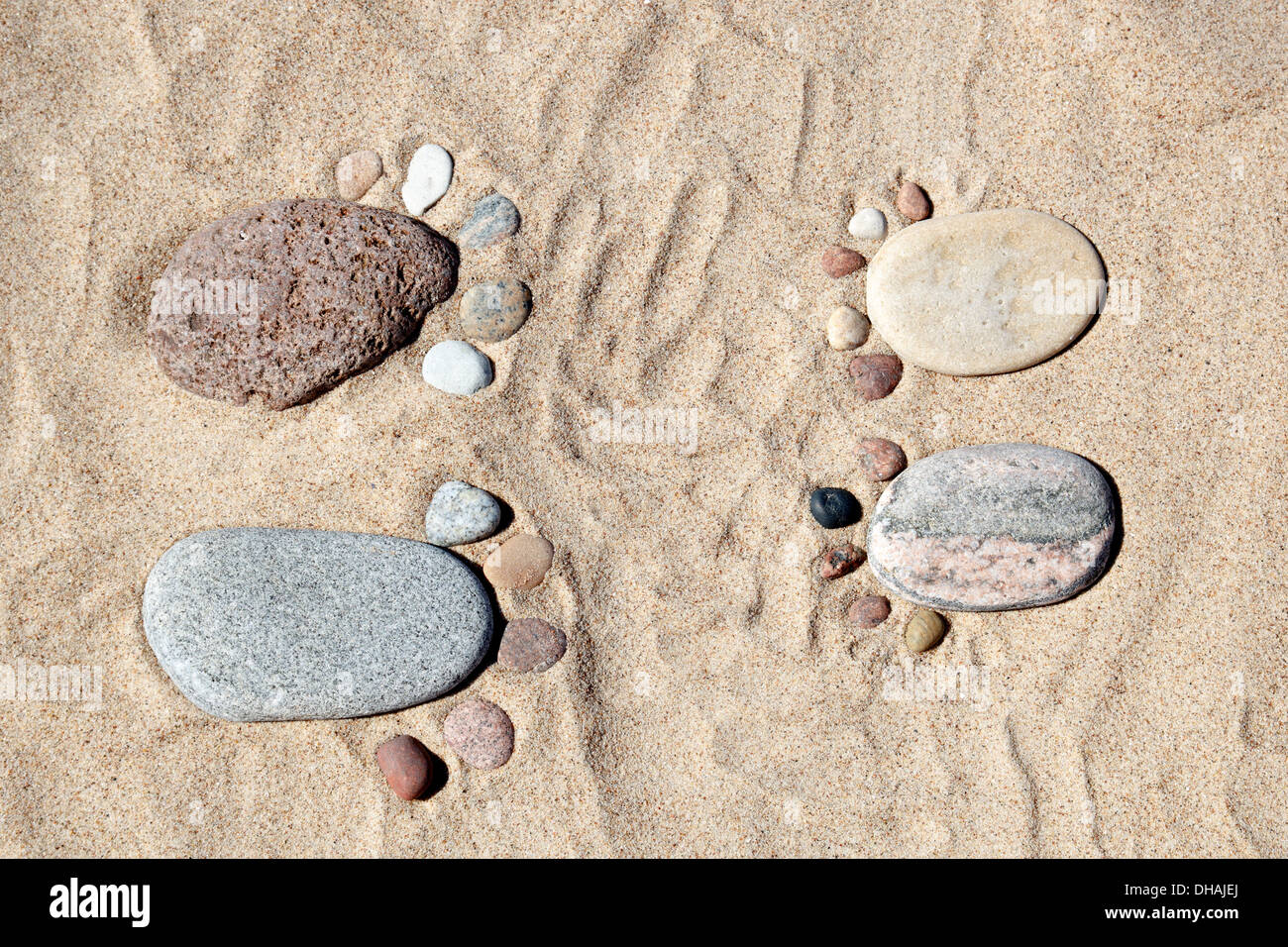 feet made from stone on the beach sand Stock Photo - Alamy