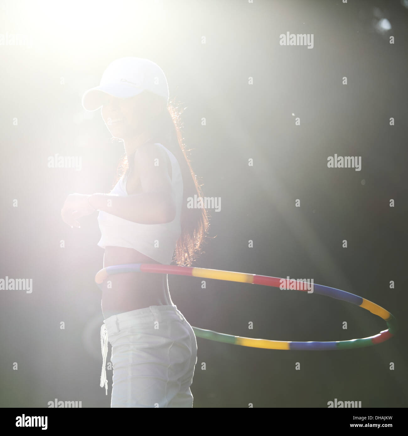 woman rotates hula hoop on nature background Stock Photo - Alamy