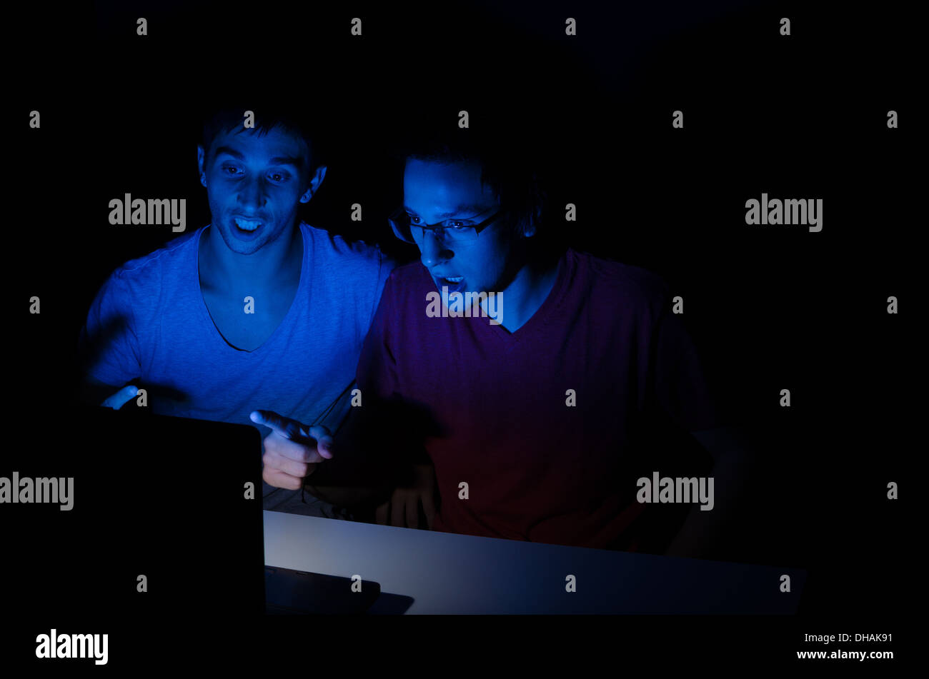 Two guys excited watching a laptop screen, a concept Stock Photo - Alamy
