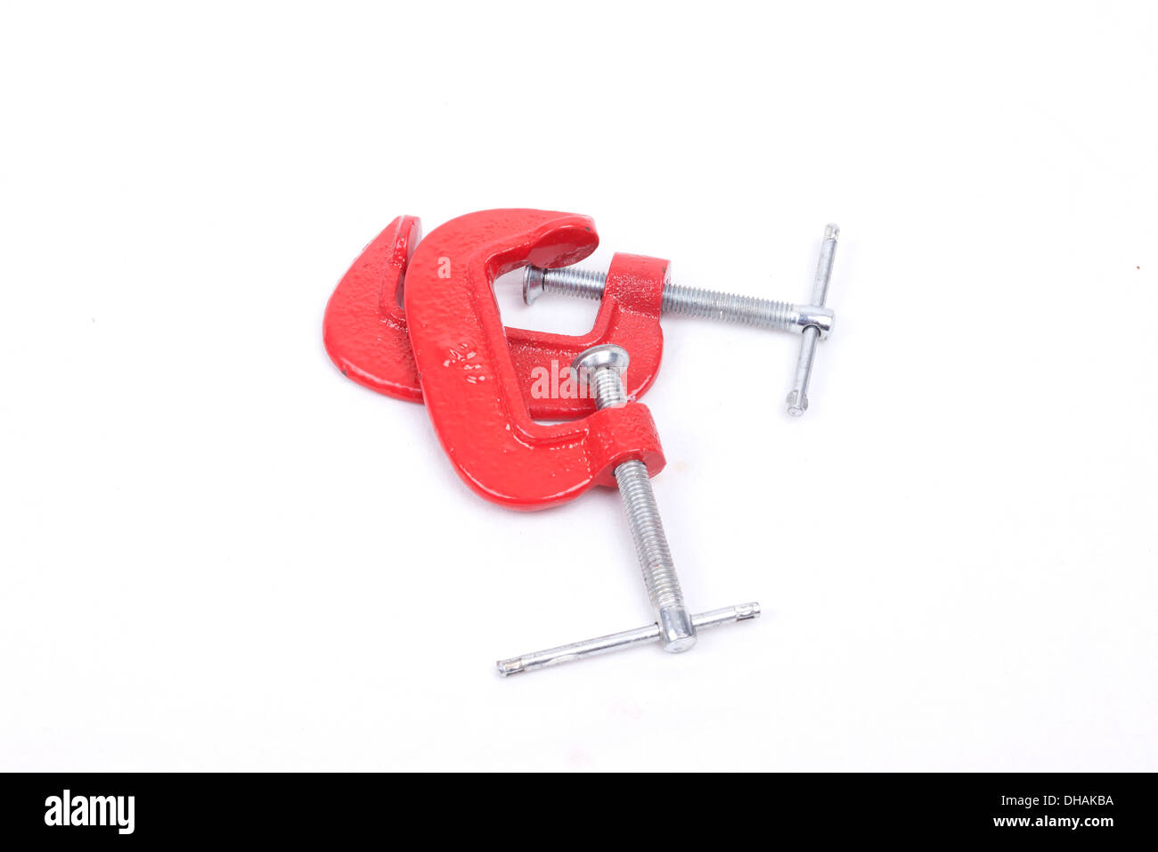 Red clamps isolated on a white background Stock Photo - Alamy