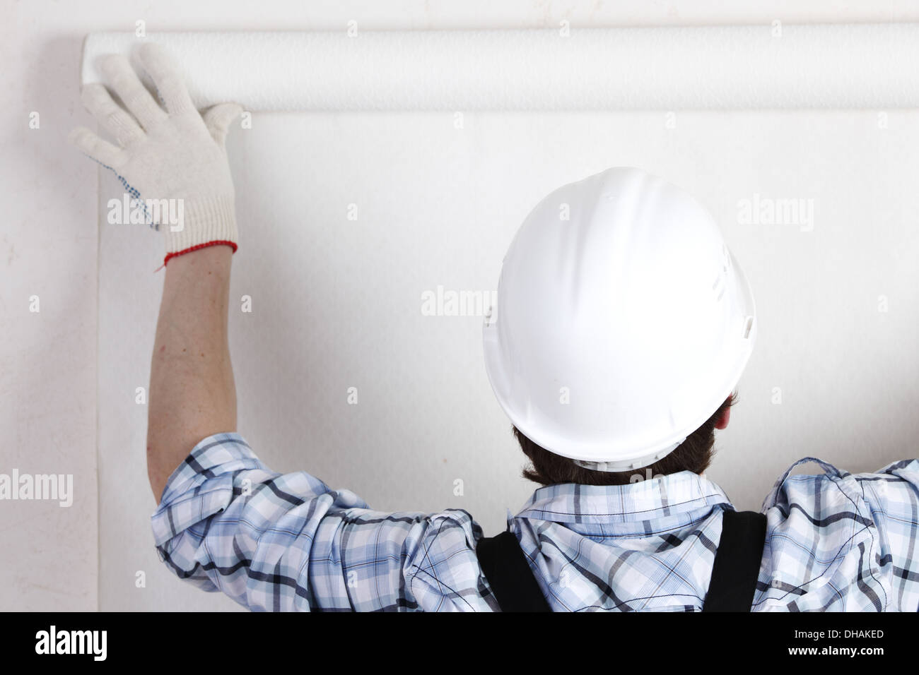 worker attaching wallpaper to wall Stock Photo - Alamy