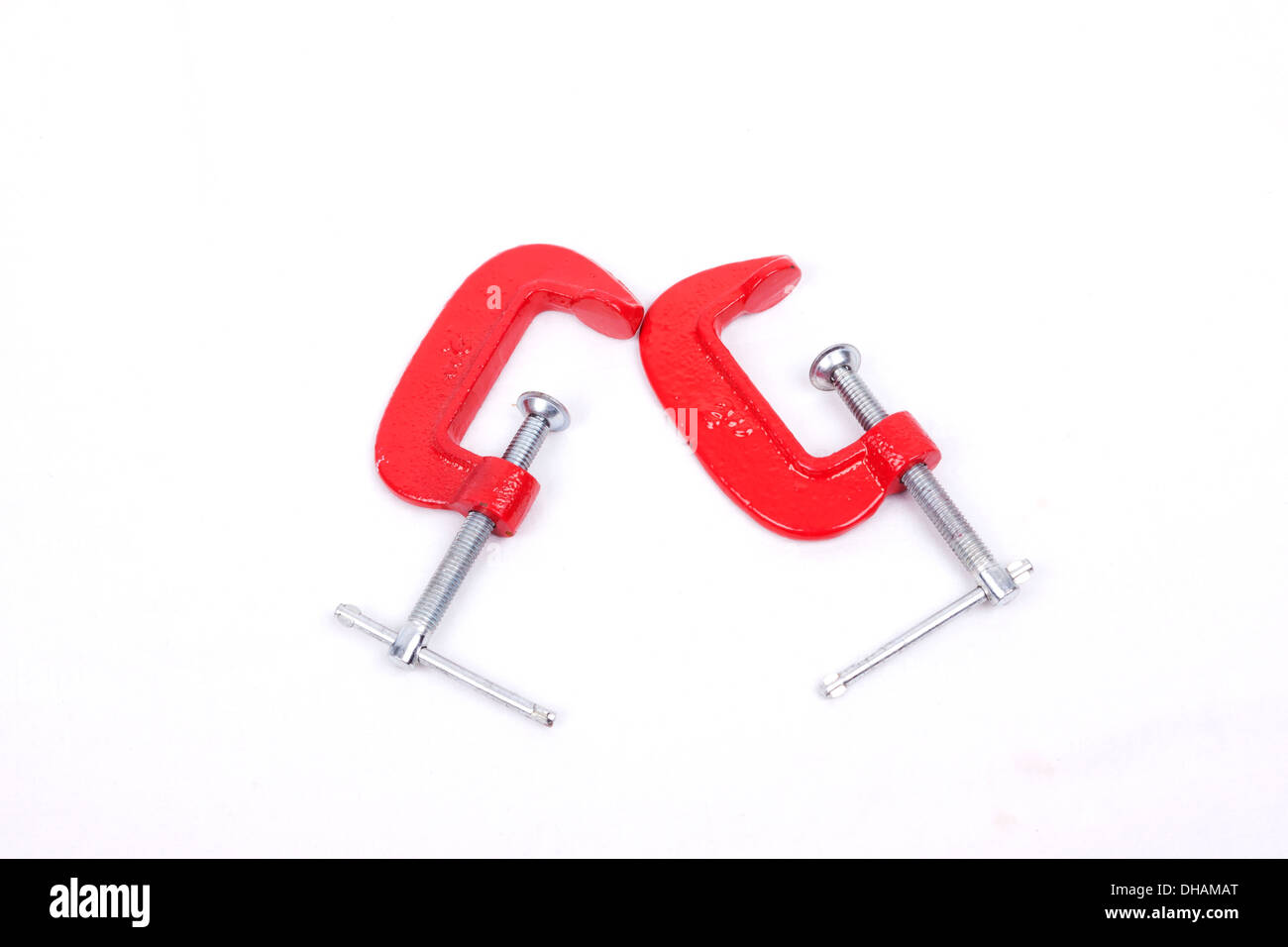 Red clamps isolated on a white background Stock Photo - Alamy