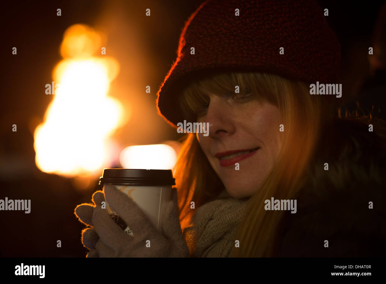 Woman drinking coffee at bonfire night celebration Stock Photo - Alamy