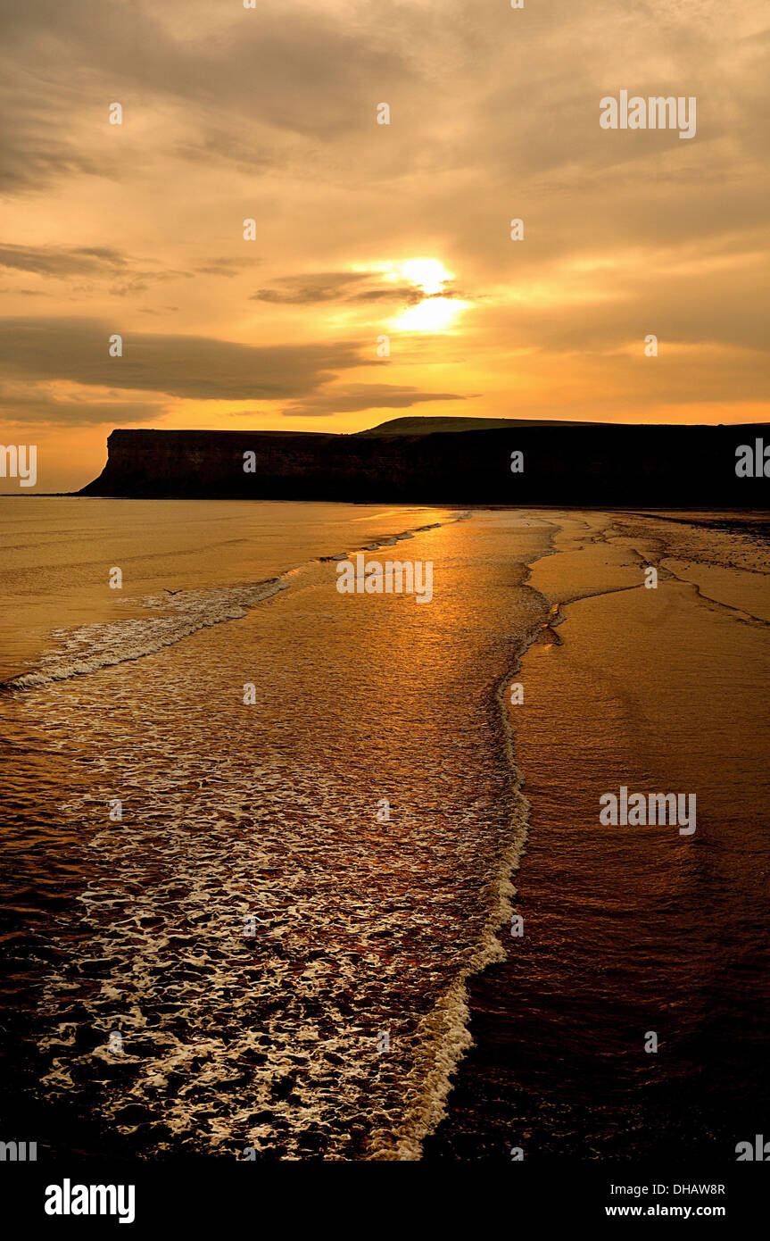Sunrise at Saltburn brings out texture in waves with headland in ...