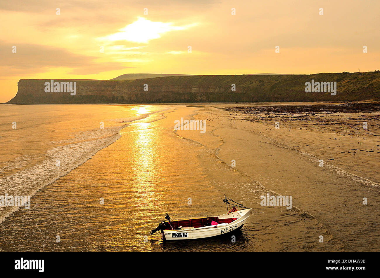 Sunrise at Saltburn brings out texture in waves with boat in foreground ...