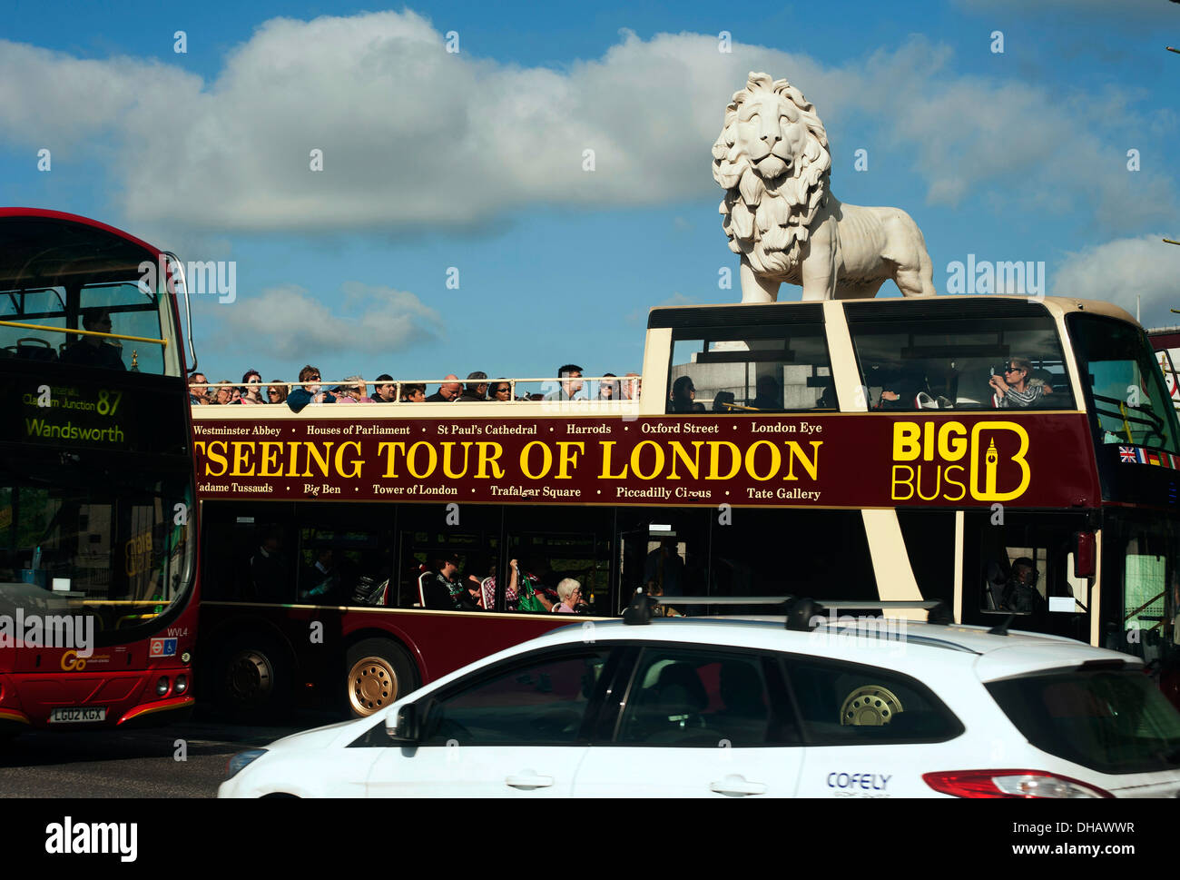 The South Bank Lion on Westminster Bridge looks out over tourist buses ...