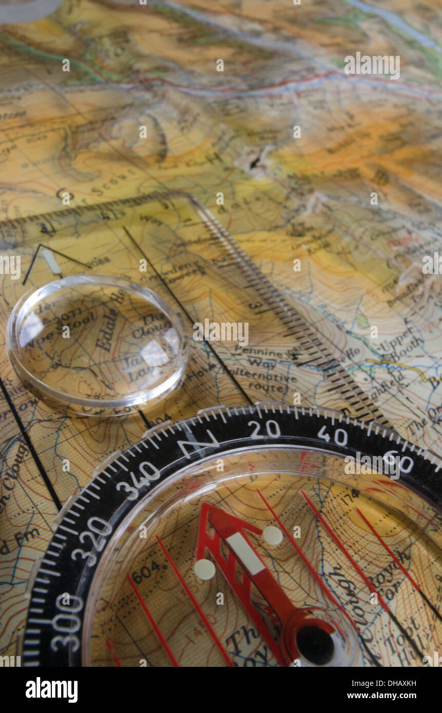 classic compass on colorful map preparing for journey with lots of ...
