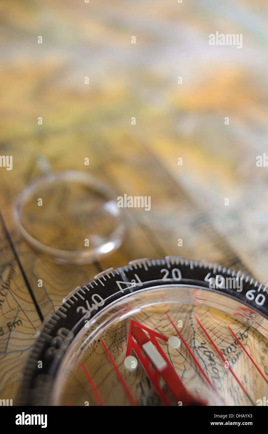 classic compass on colorful map preparing for journey with lots of ...