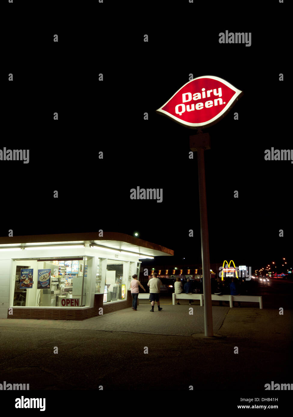 A nighttime view of a crowd waiting in line for ice cream at the Dairy ...
