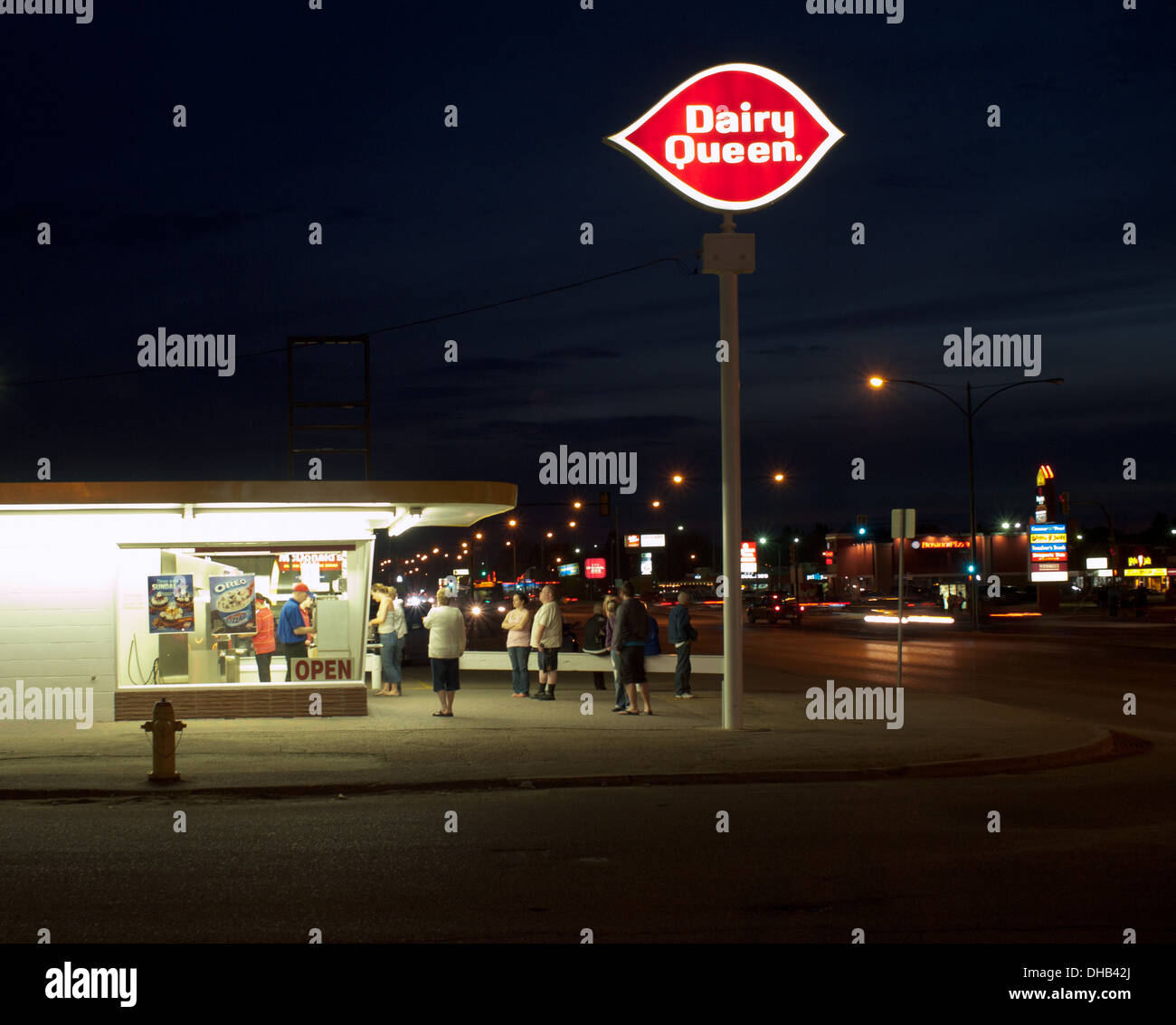 A nighttime view of a crowd waiting in line for ice cream at the Dairy ...