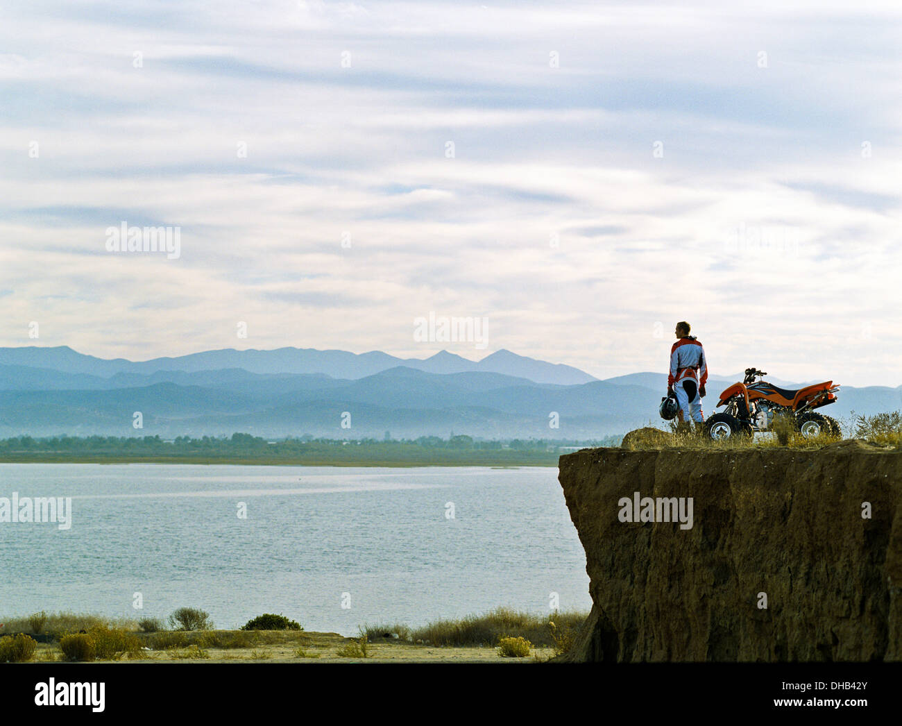 ATV on cliff at dawn, model Gunner Wright, model released Stock Photo ...
