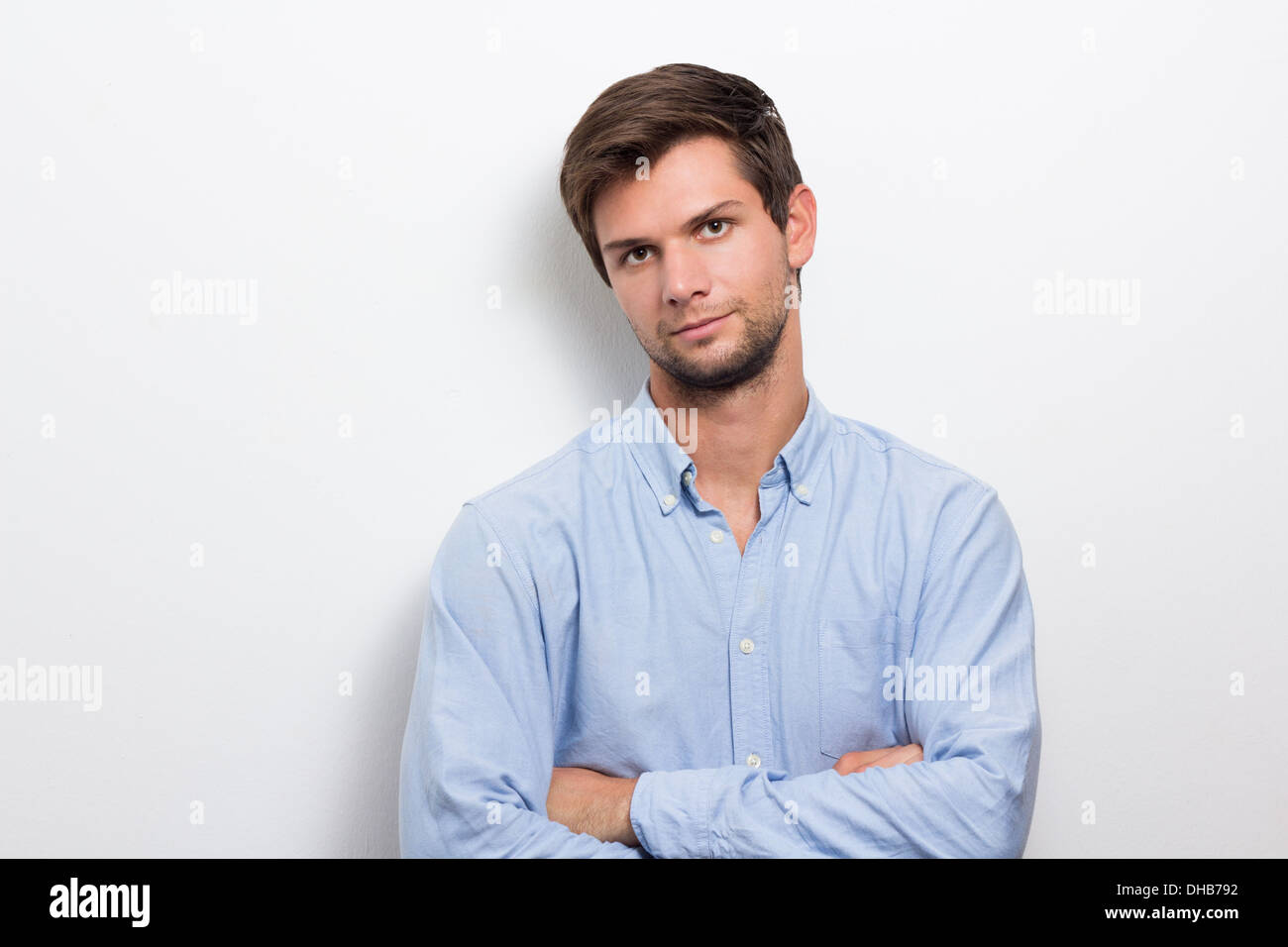 Brunette man with one arm folded wearing a blue shirt Stock Photo - Alamy