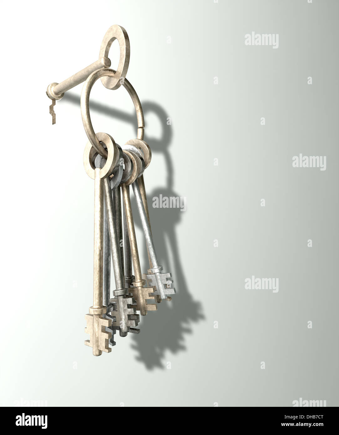 A set of old keys on a hoop hanging from one inserted into a key hole ...