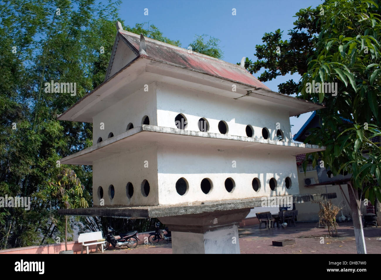 A concrete bird house stands in the afternoon sunlight on the Mekong ...