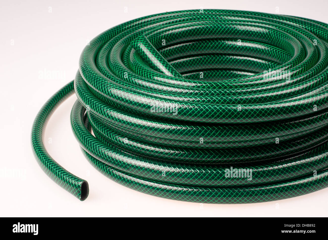 Green hose on a white background Stock Photo - Alamy