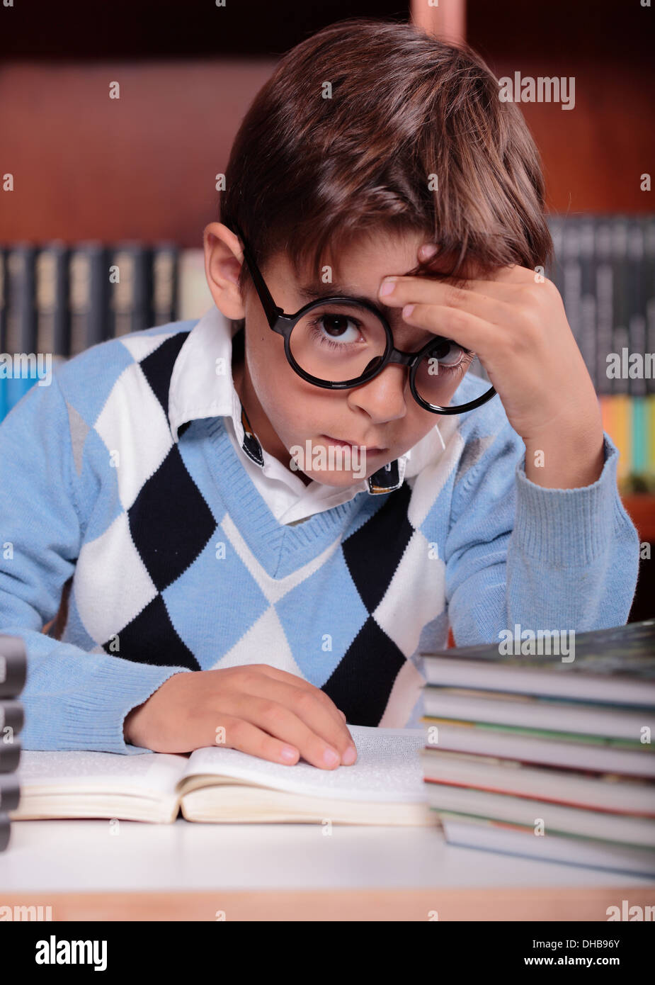 Child studying in the library Stock Photo - Alamy