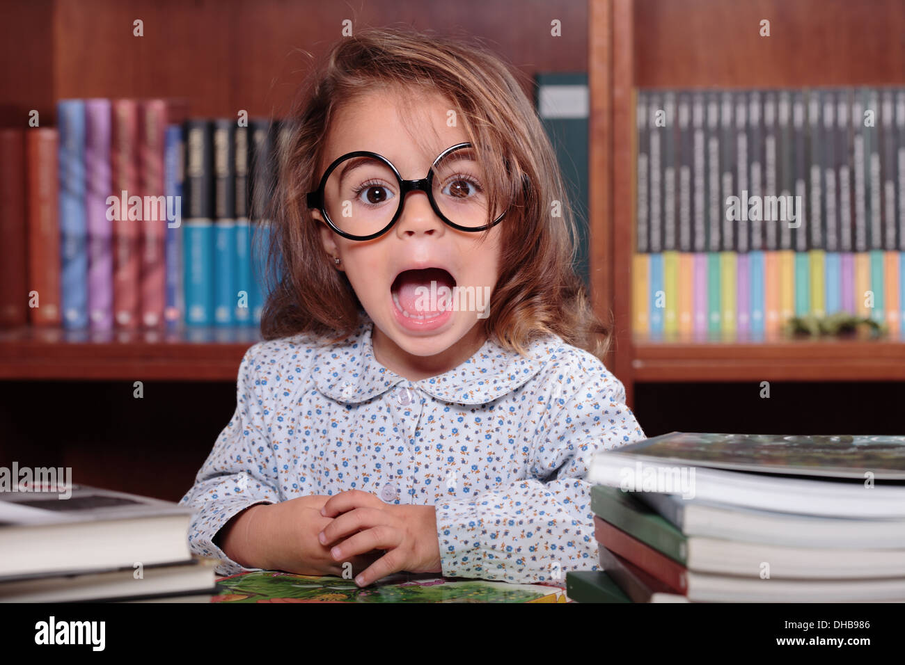 beautiful caucasian girl screaming in the library Stock Photo - Alamy
