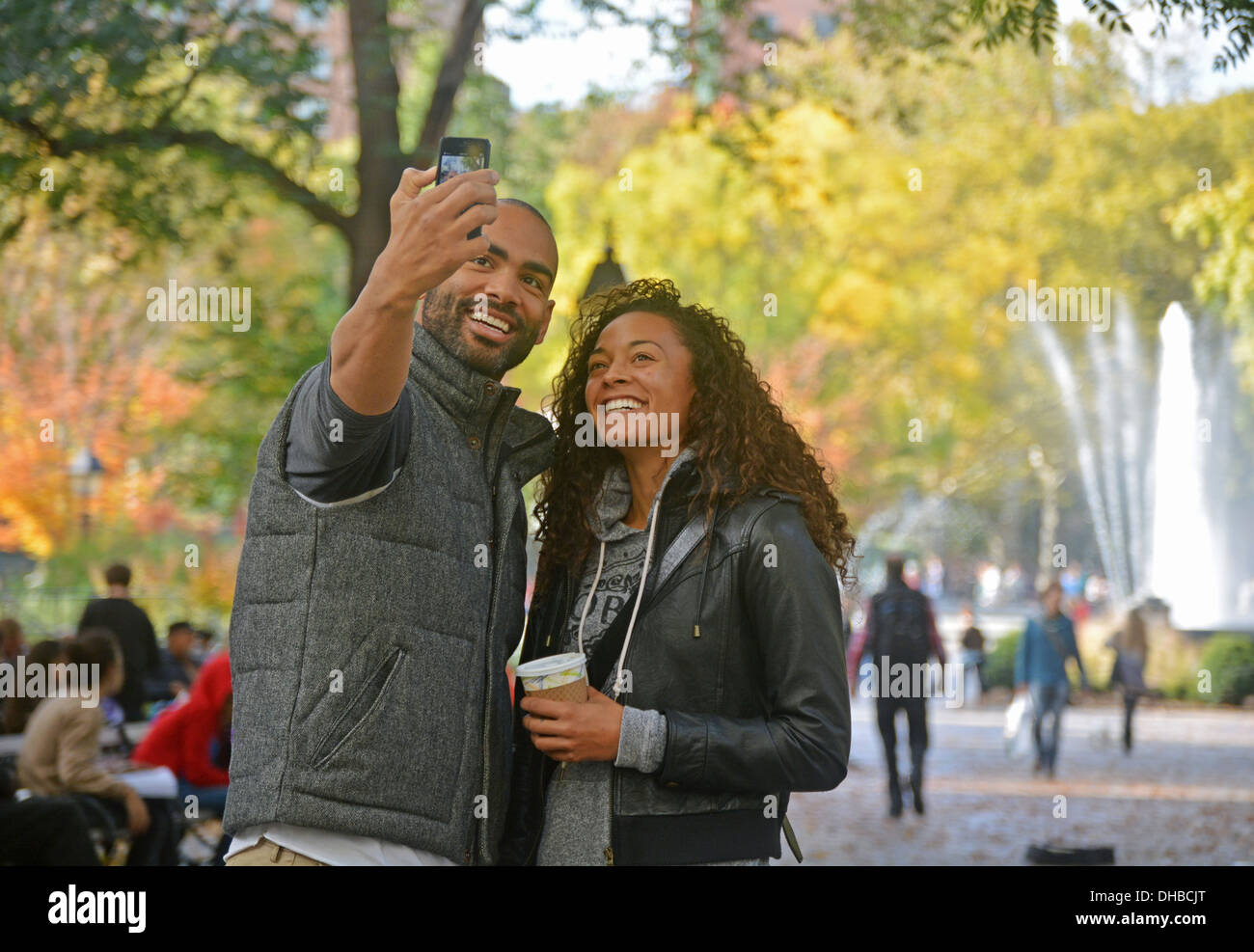 A very nice looking couple taking a self portrait in Washington Square ...