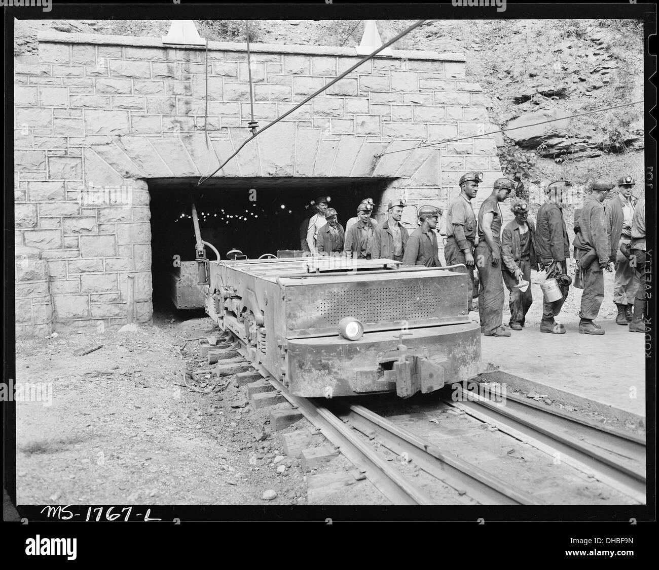 At a mine, the motor hauling a man trip stops just after emerging from ...
