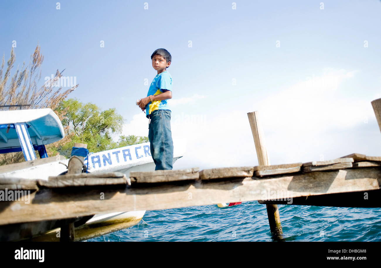 Guatemalan boy looks out at the deck at San Marcos la Laguna, Solola ...