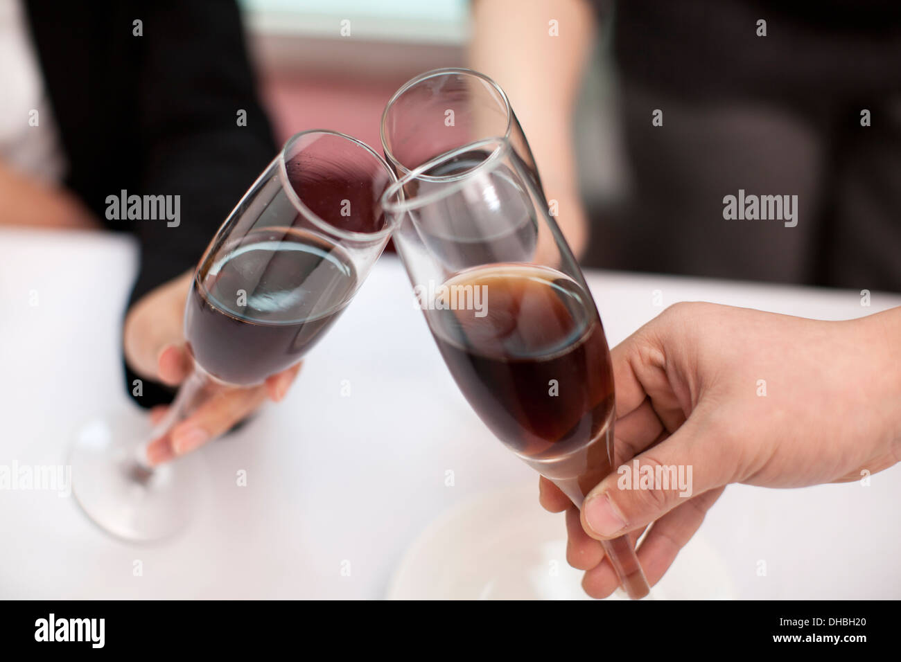 Businesspeople toasting glasses at restaurant table,close-up Stock ...