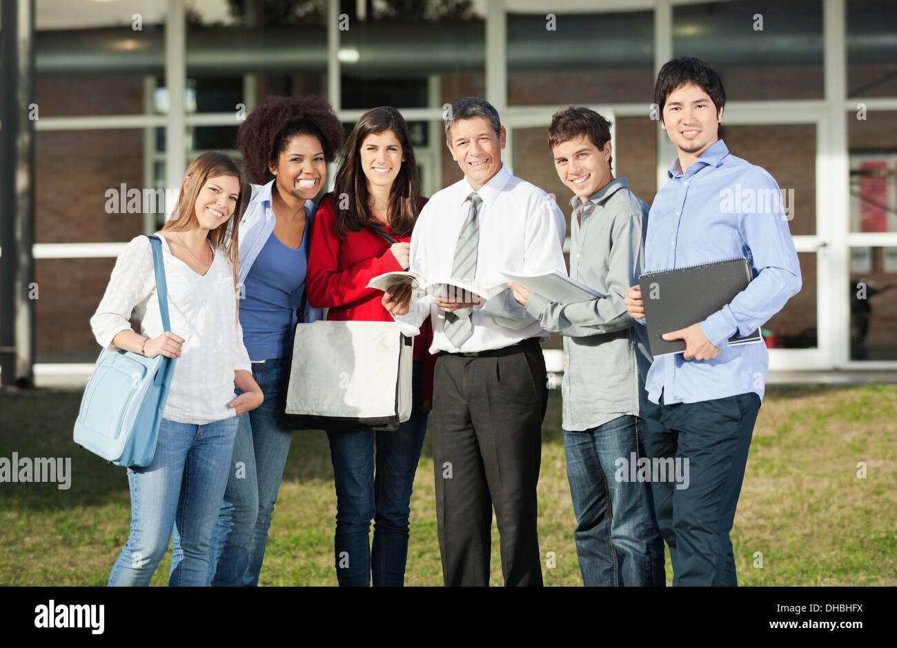 Happy Students With Teacher Standing On College Campus Stock Photo - Alamy